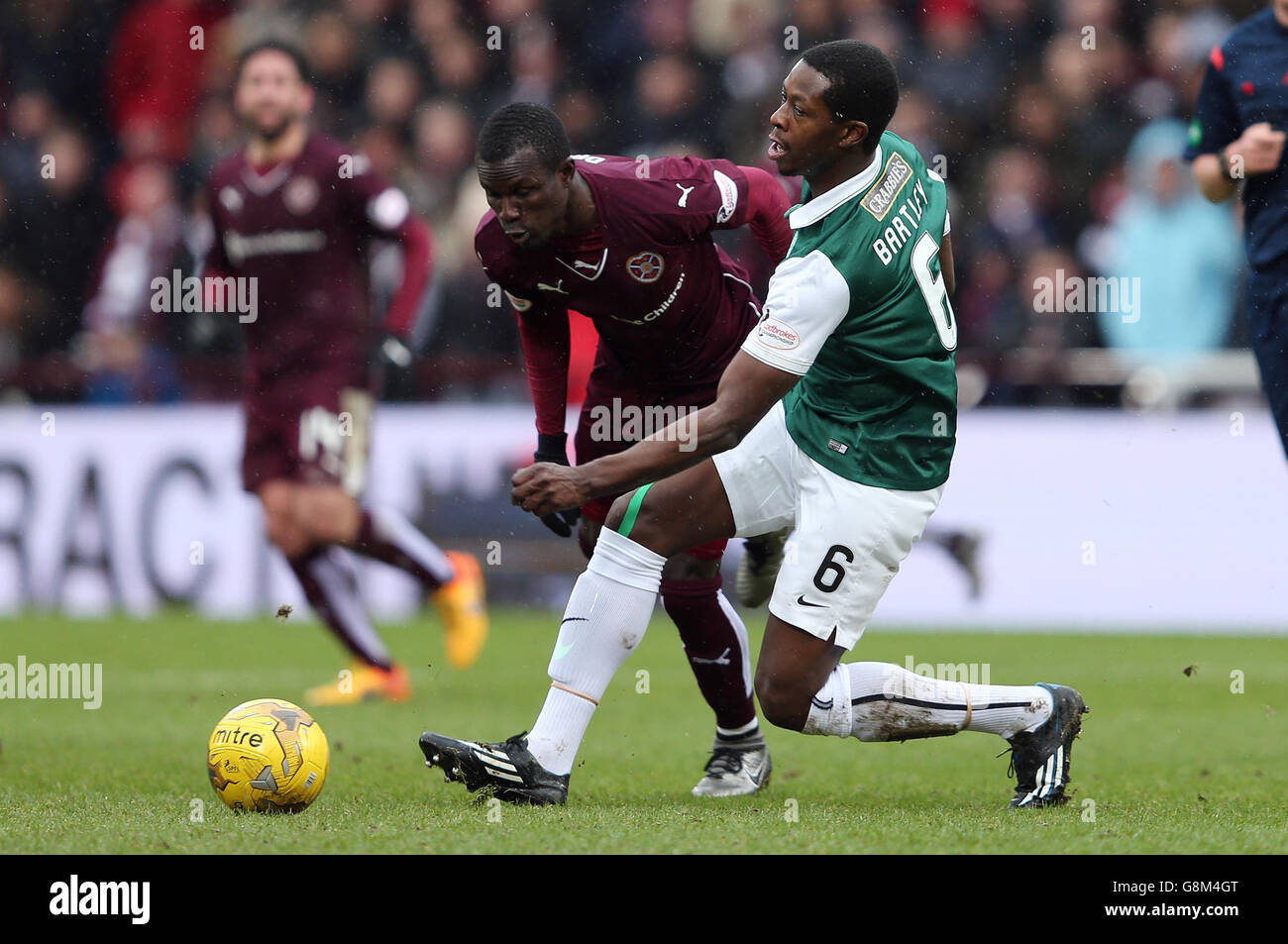 Hearts' Abiola Dauda is challenged by Hibernian's Marvin Bartley during ...