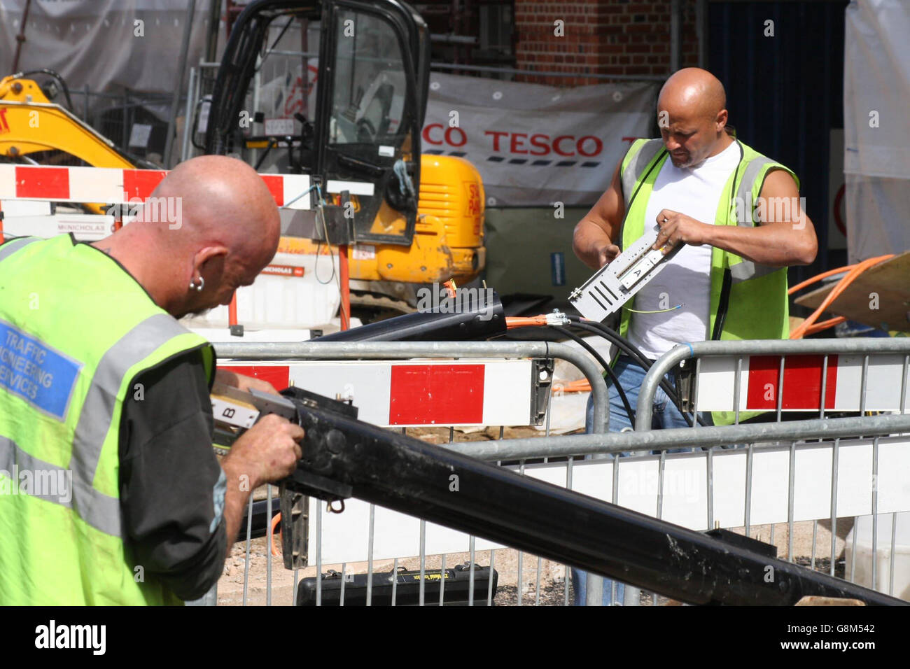 Construction workers continue work on a new Tesco supermarket being ...