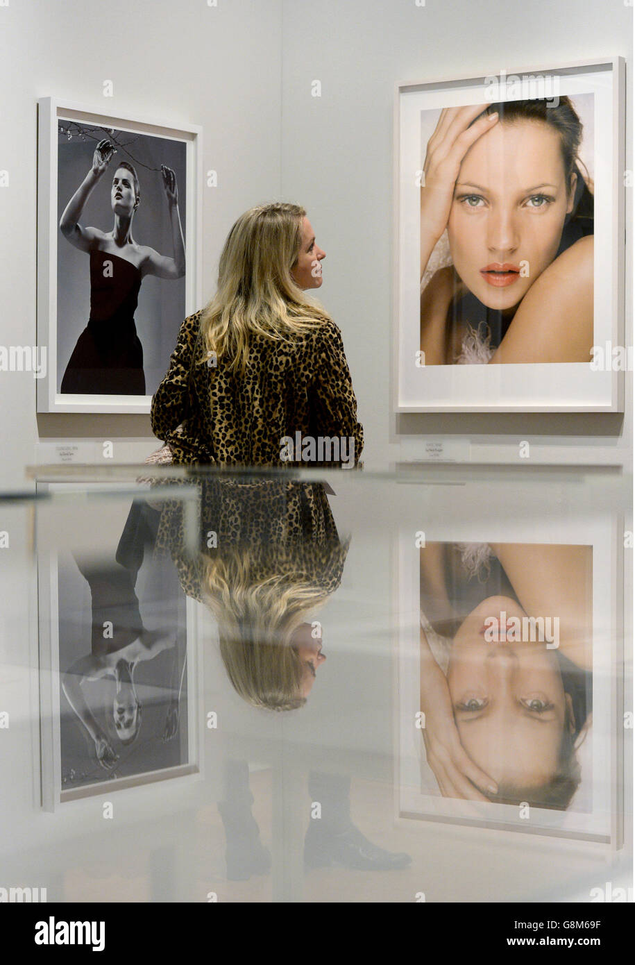 A woman views a portrait of Kate Moss during a press view of Vogue 100 ...
