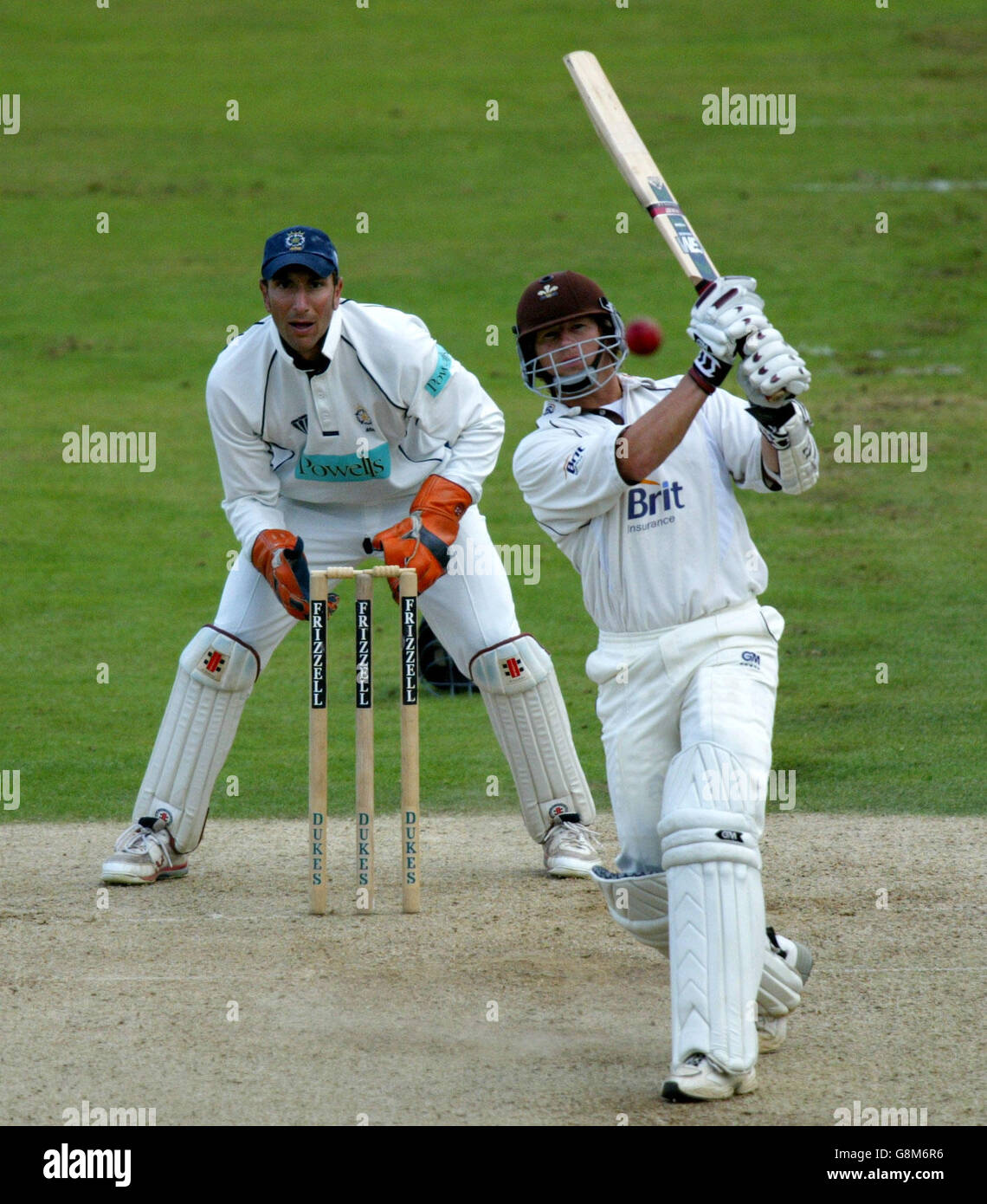 Surrey's Jonathan Batty hits a boundary off the bowling of Hampshire's ...