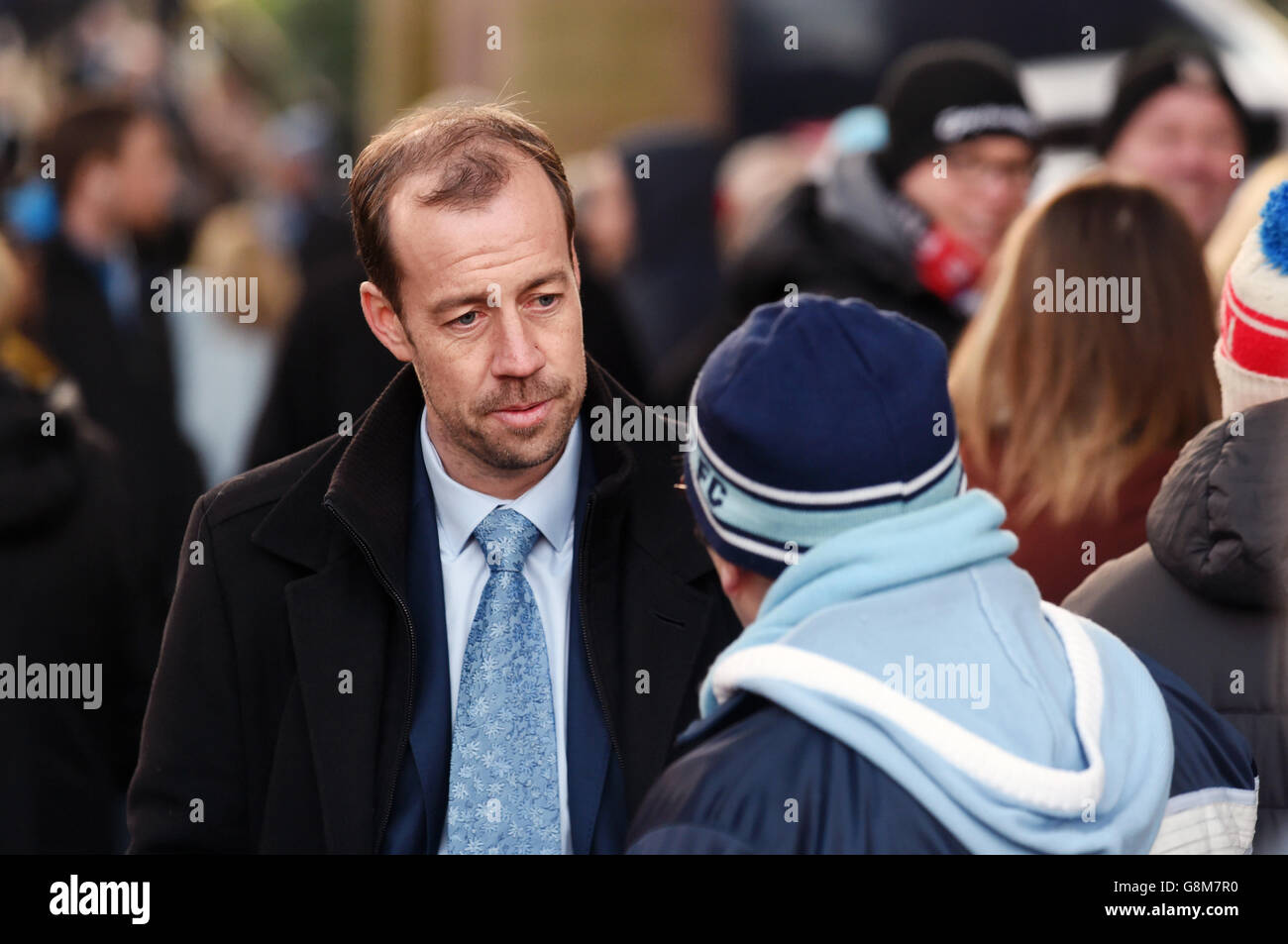 Coventry City coach Jamie Clapham speaks to a fan before the memorial ...