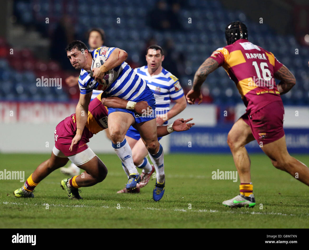 Wigan Warriors' Ben Flower is tackled by Huddersfield Giants' Ukuma Ta ...