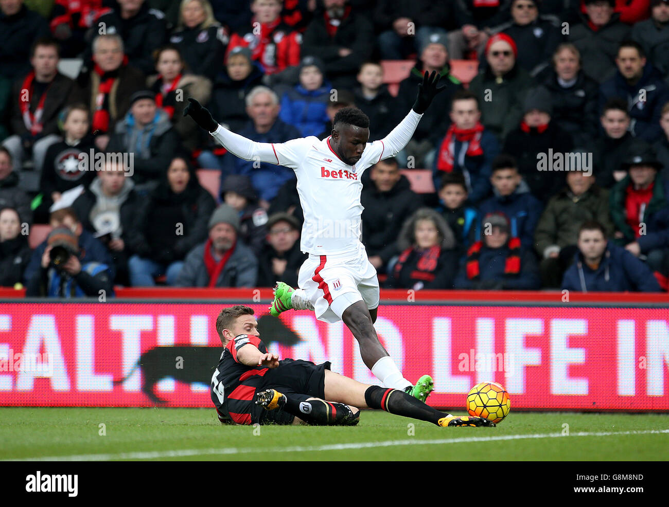 Stoke City's Mame Biram Diouf and AFC Bournemouth's Simon Francis ...