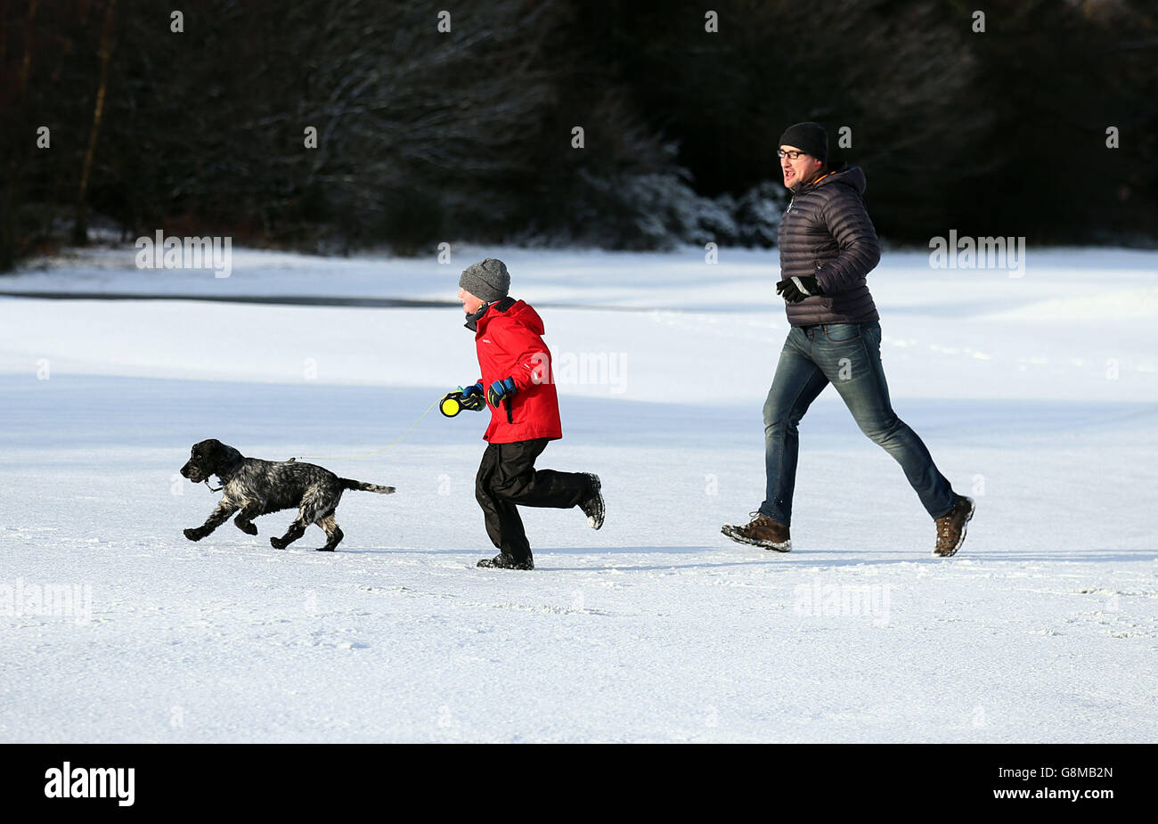 Michael and his son Theo Paton chase their dog Jarvis through Falkirk ...