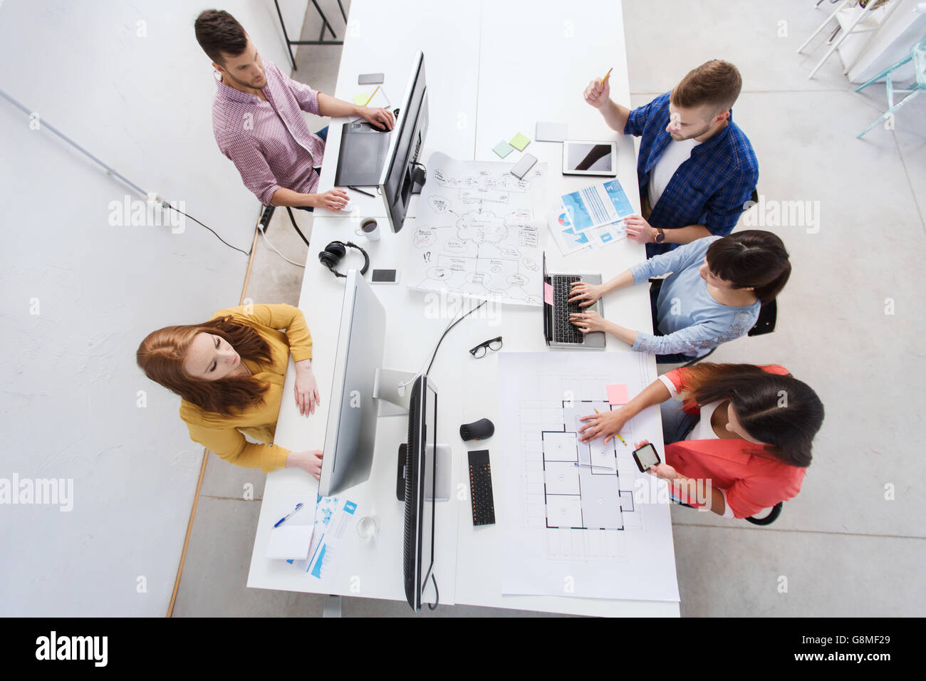 creative team with computers, blueprint at office Stock Photo - Alamy