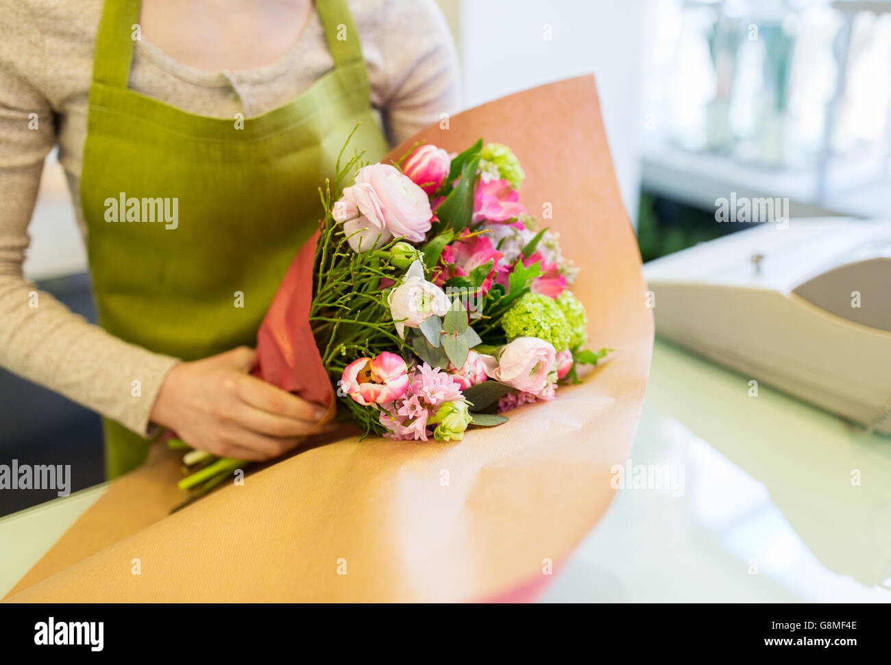 close up of woman packing bunch at flower shop Stock Photo - Alamy