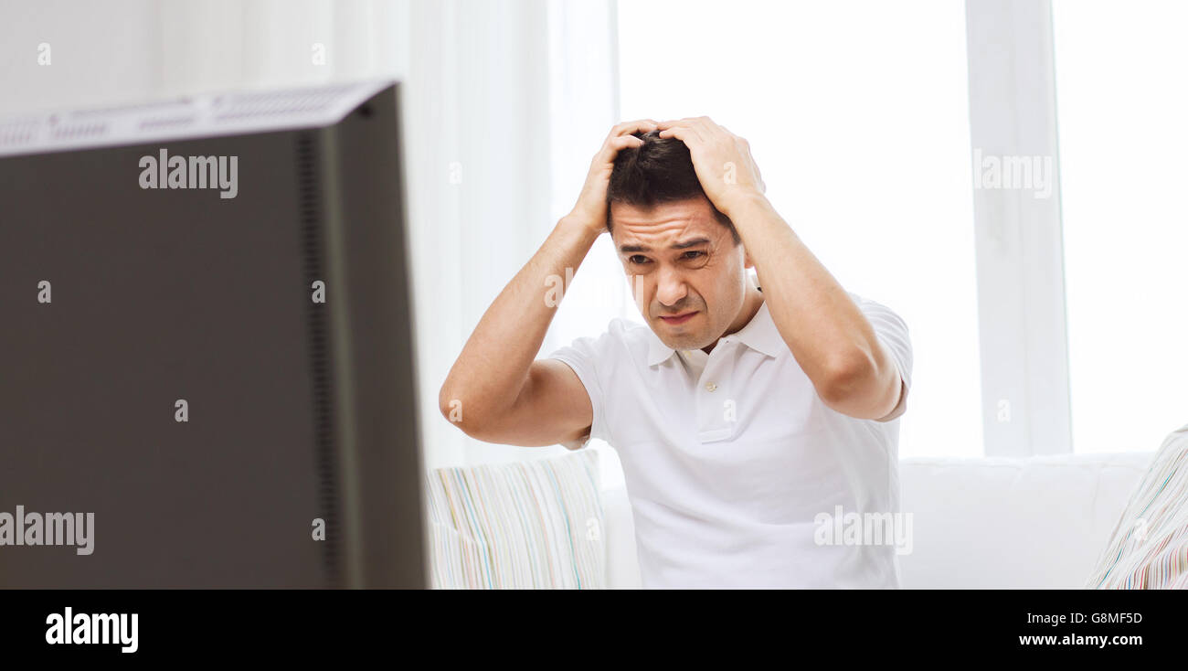 disappointed man watching tv at home Stock Photo - Alamy