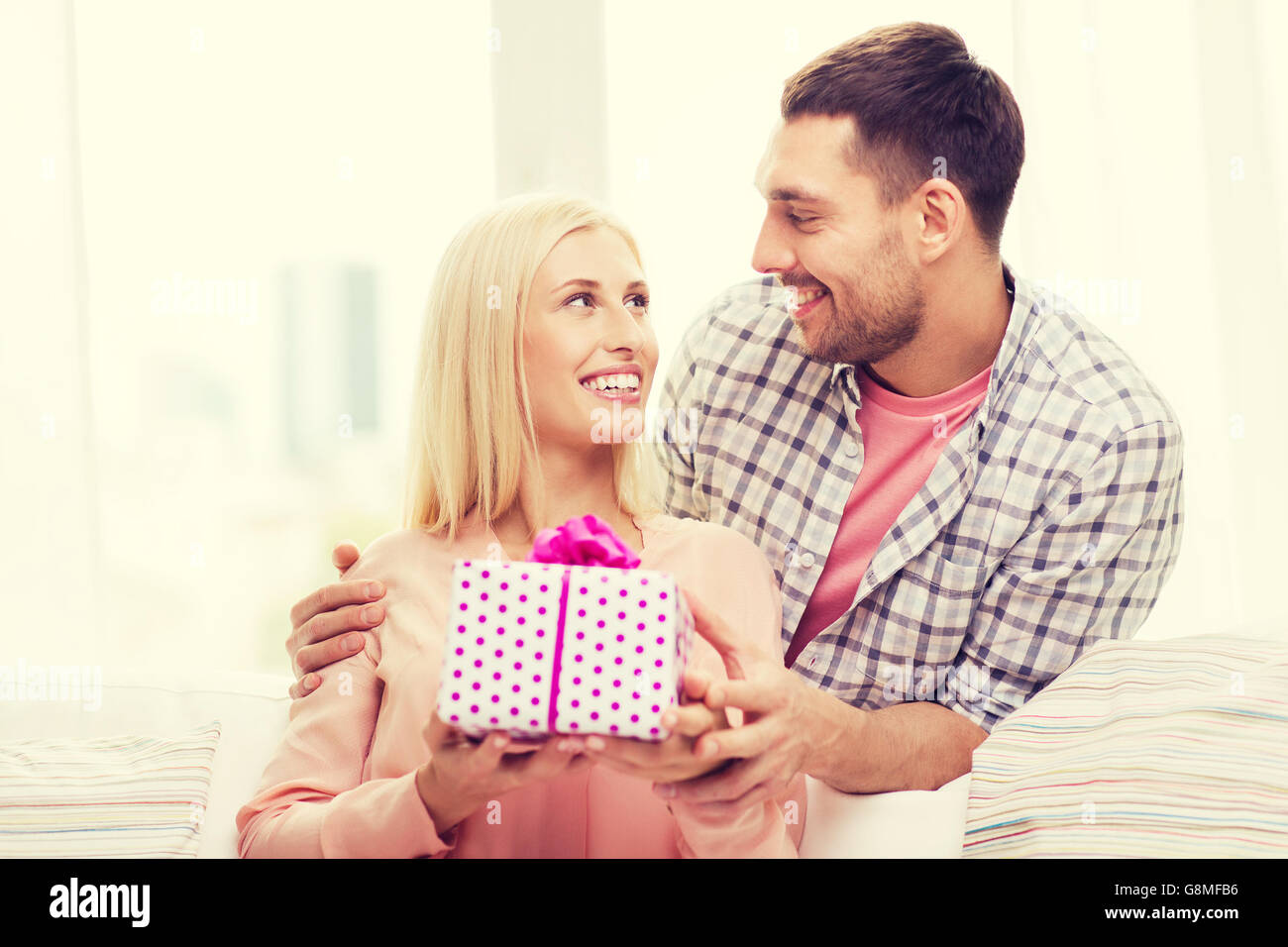 happy man giving woman gift box at home Stock Photo - Alamy