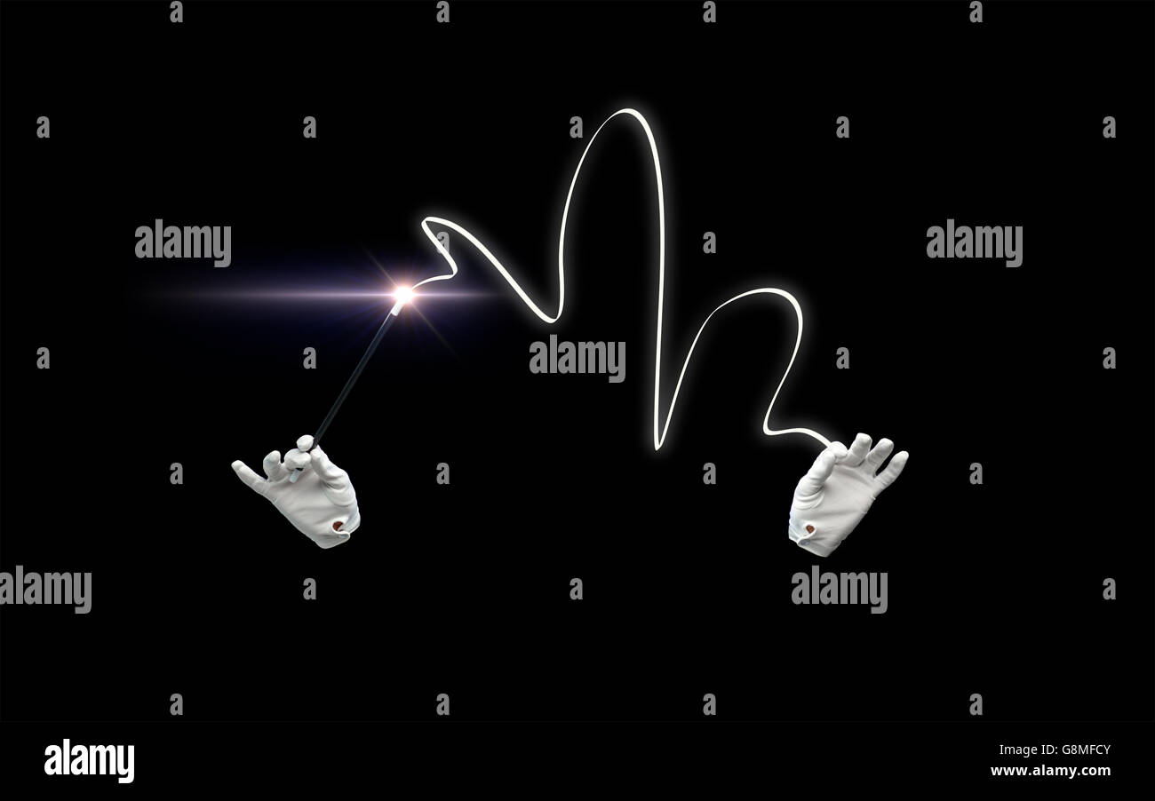 magician hands with magic wand showing trick Stock Photo - Alamy