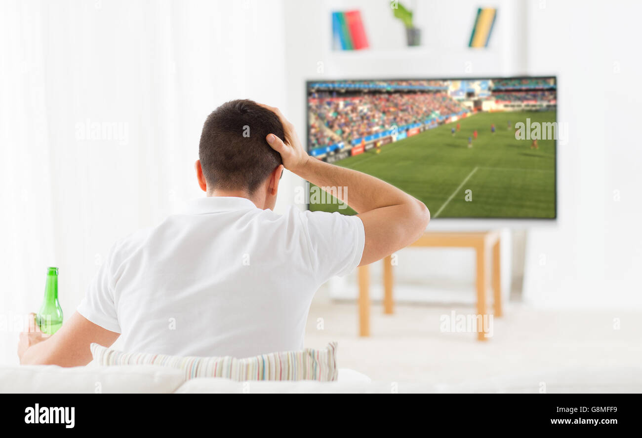 man watching football or soccer game on tv at home Stock Photo - Alamy
