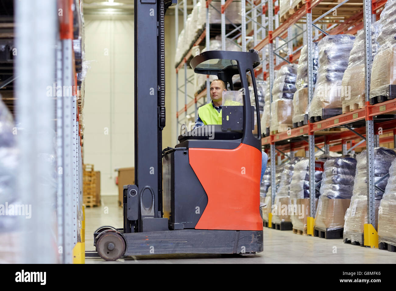 man operating forklift loader at warehouse Stock Photo - Alamy