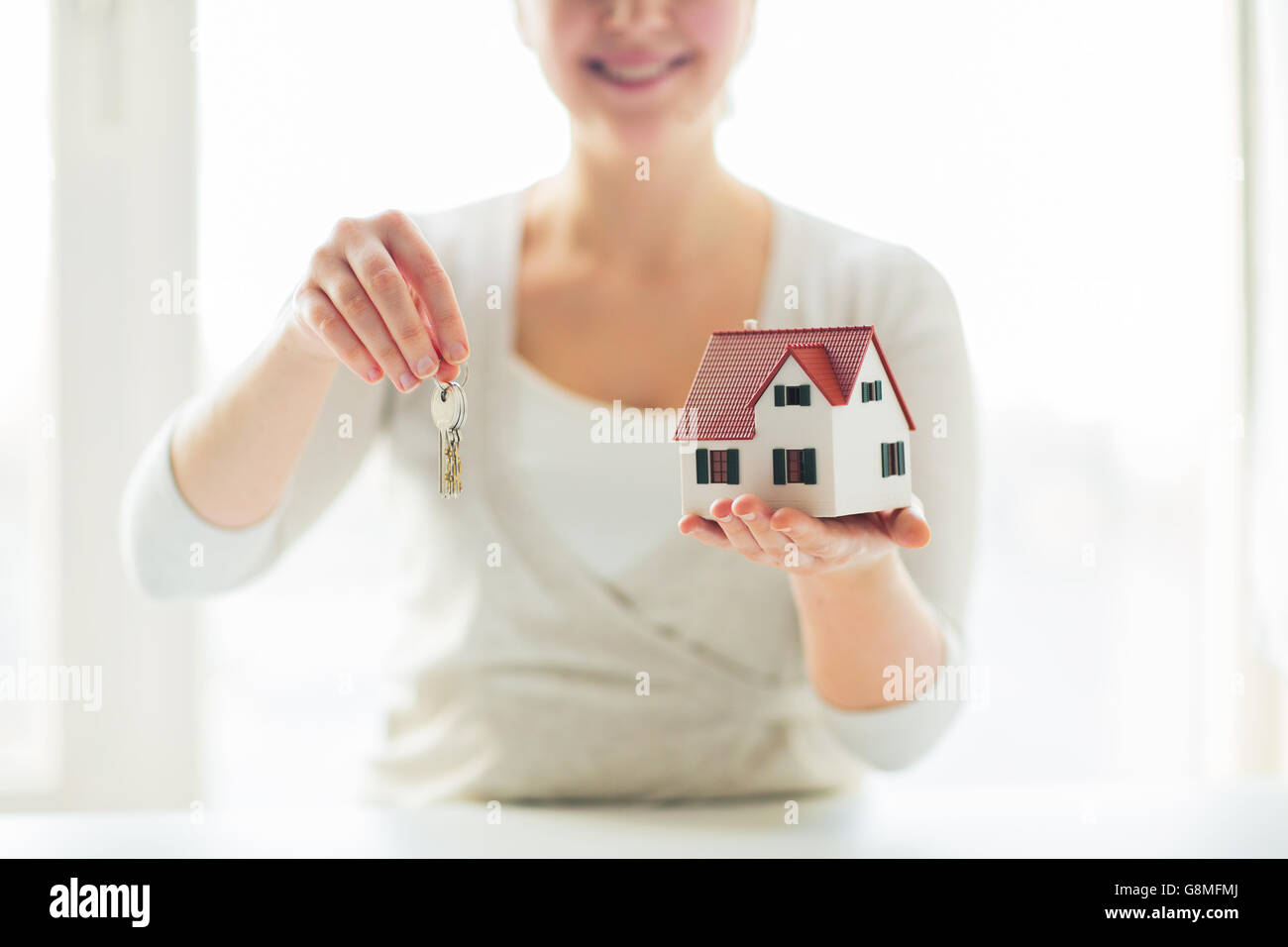 Woman showing house key hi-res stock photography and images - Alamy