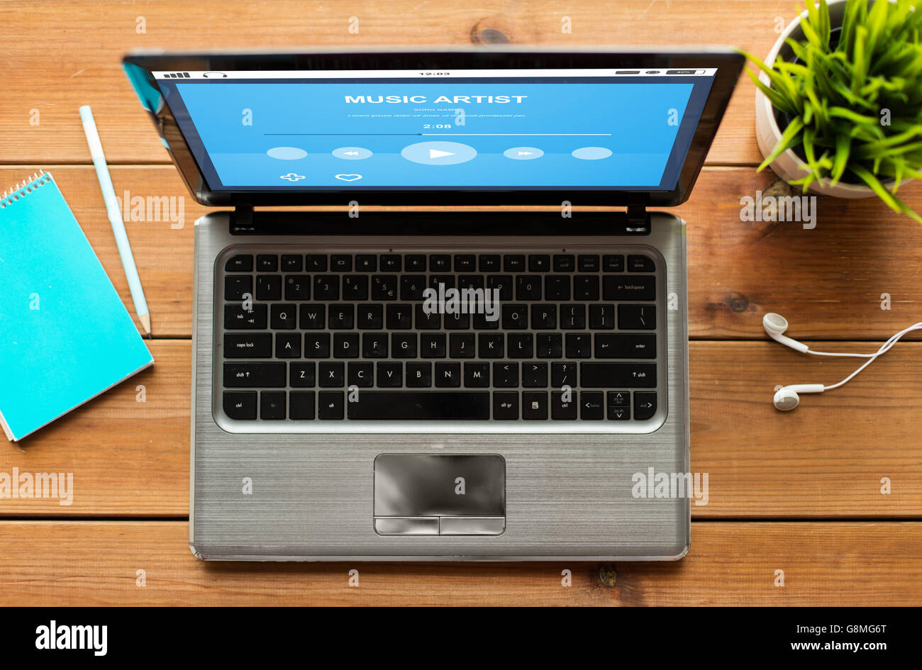 close up of laptop with music player on table Stock Photo - Alamy