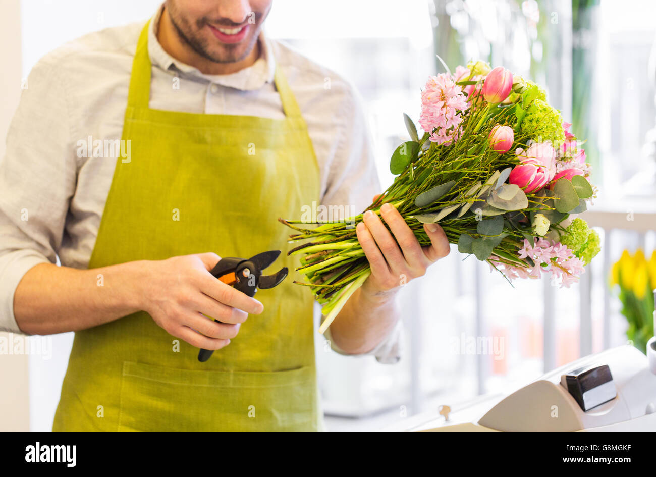 close up of florist man with flowers and pruner Stock Photo - Alamy