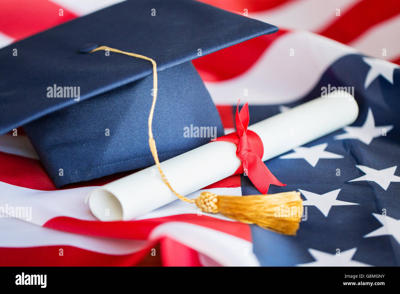 bachelor hat and diploma on american flag Stock Photo - Alamy