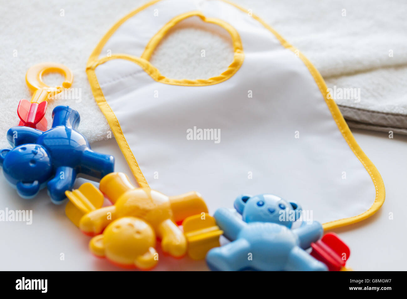 close up of baby rattle and bib for newborn Stock Photo - Alamy