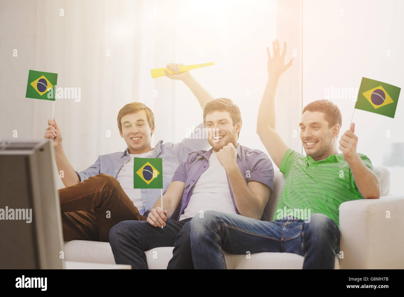 happy male friends with flags and vuvuzela Stock Photo - Alamy