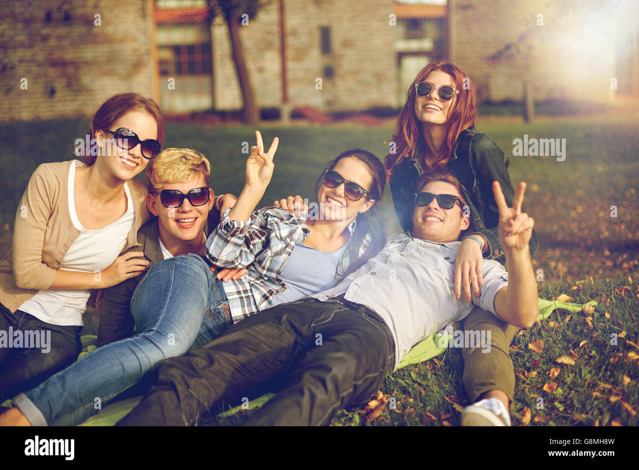 group of happy students showing victory gesture Stock Photo - Alamy
