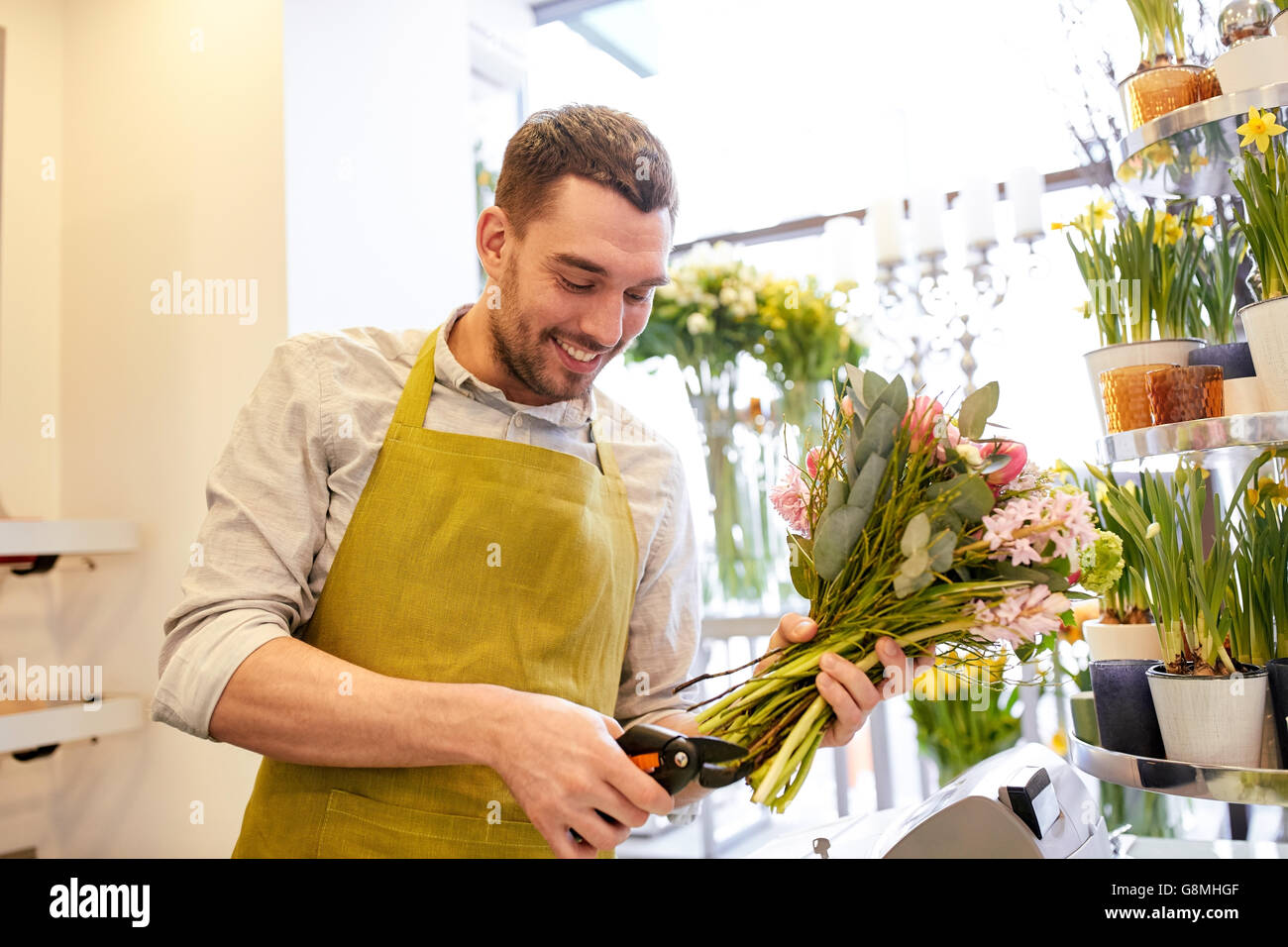 smiling florist man making bunch at flower shop Stock Photo - Alamy