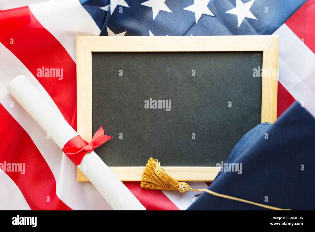 board, bachelor hat and diploma on american flag Stock Photo - Alamy