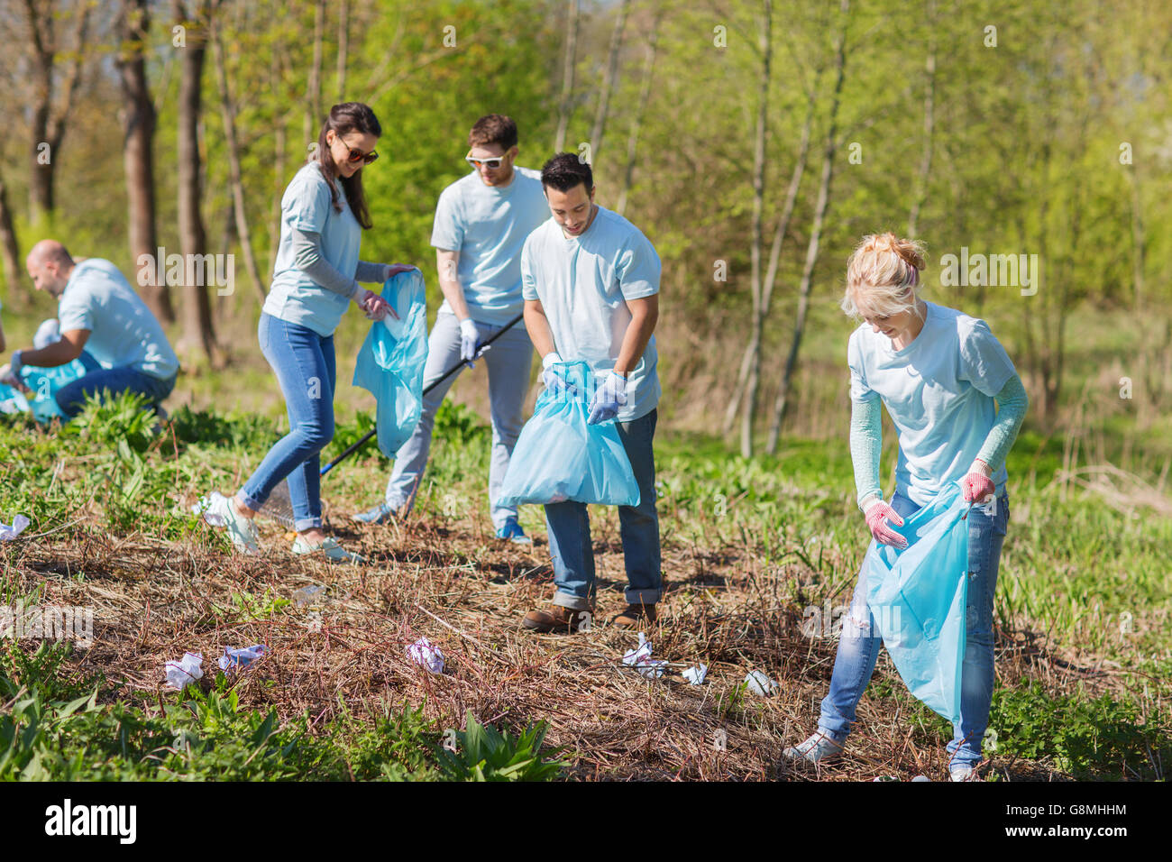 volunteers with garbage bags cleaning park area Stock Photo - Alamy