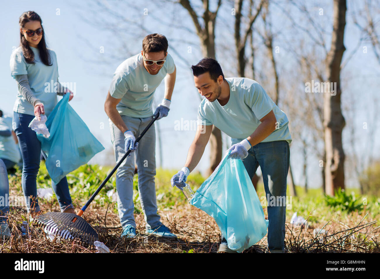 volunteers with garbage bags cleaning park area Stock Photo - Alamy