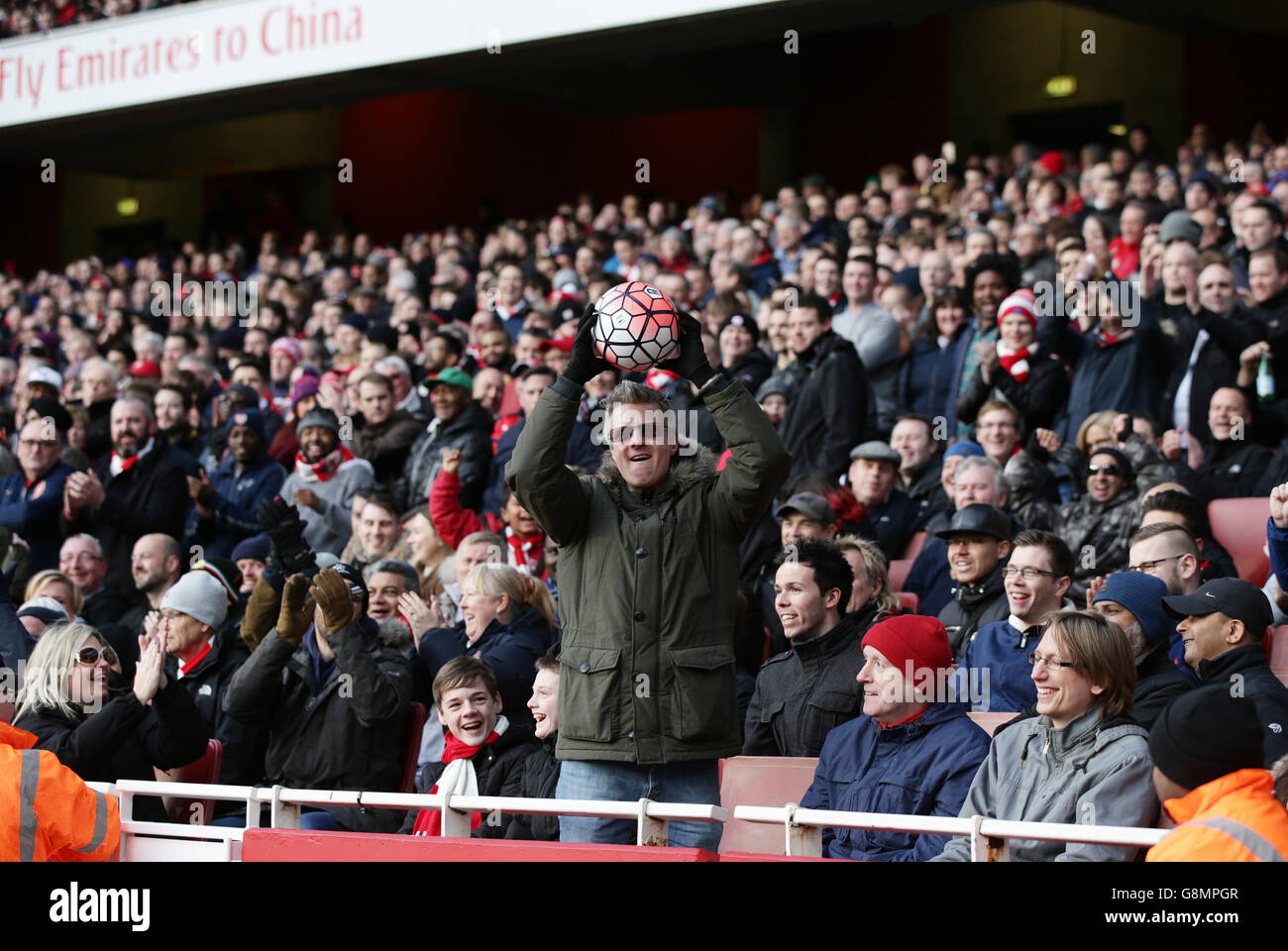 An arsenal fan in the crowd catches a ball hi-res stock photography and ...