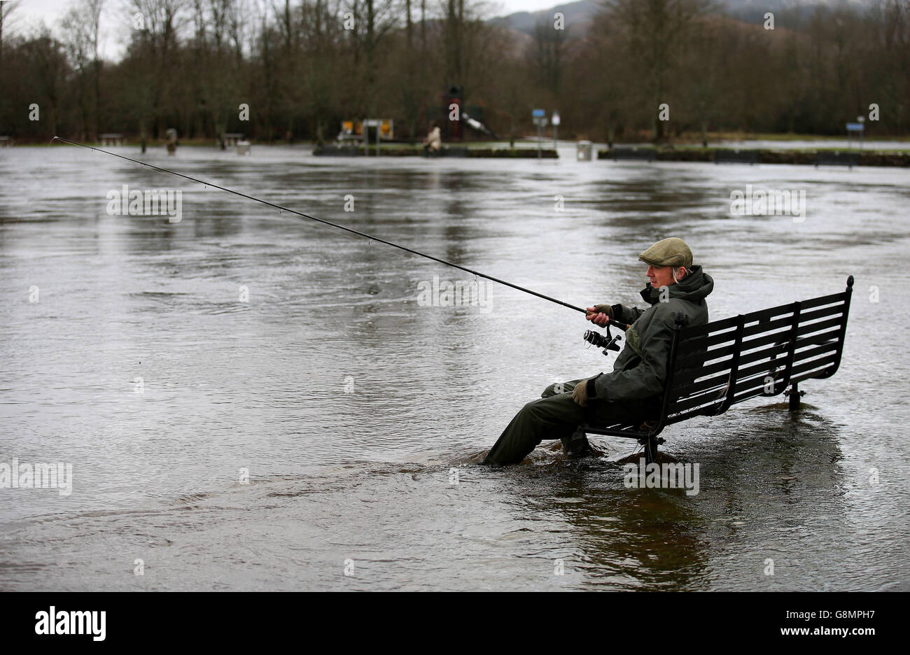 Fisherman Andy Casey from Clydebank uses a flooded bench at the River ...