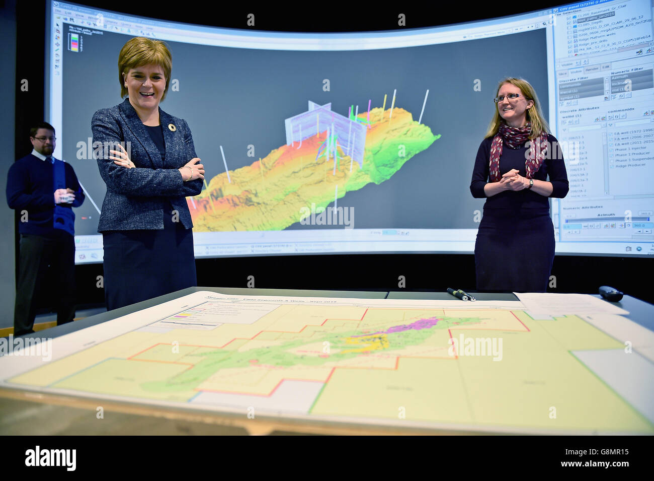 First Minister Nicola Sturgeon (second left) looks at graphs and ...