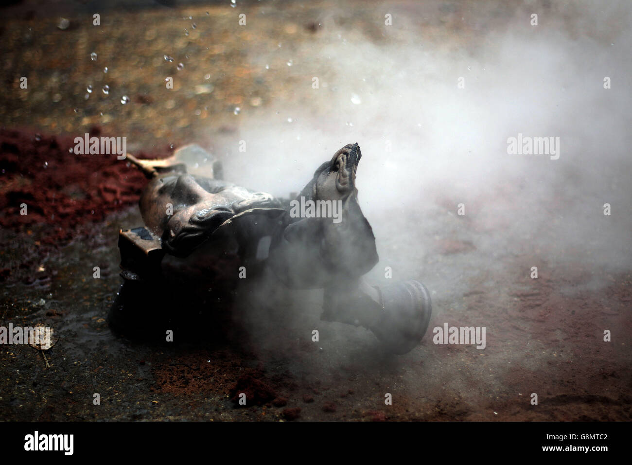 Bronze metal statues are cooled down as they are made into BAFTA masks ...