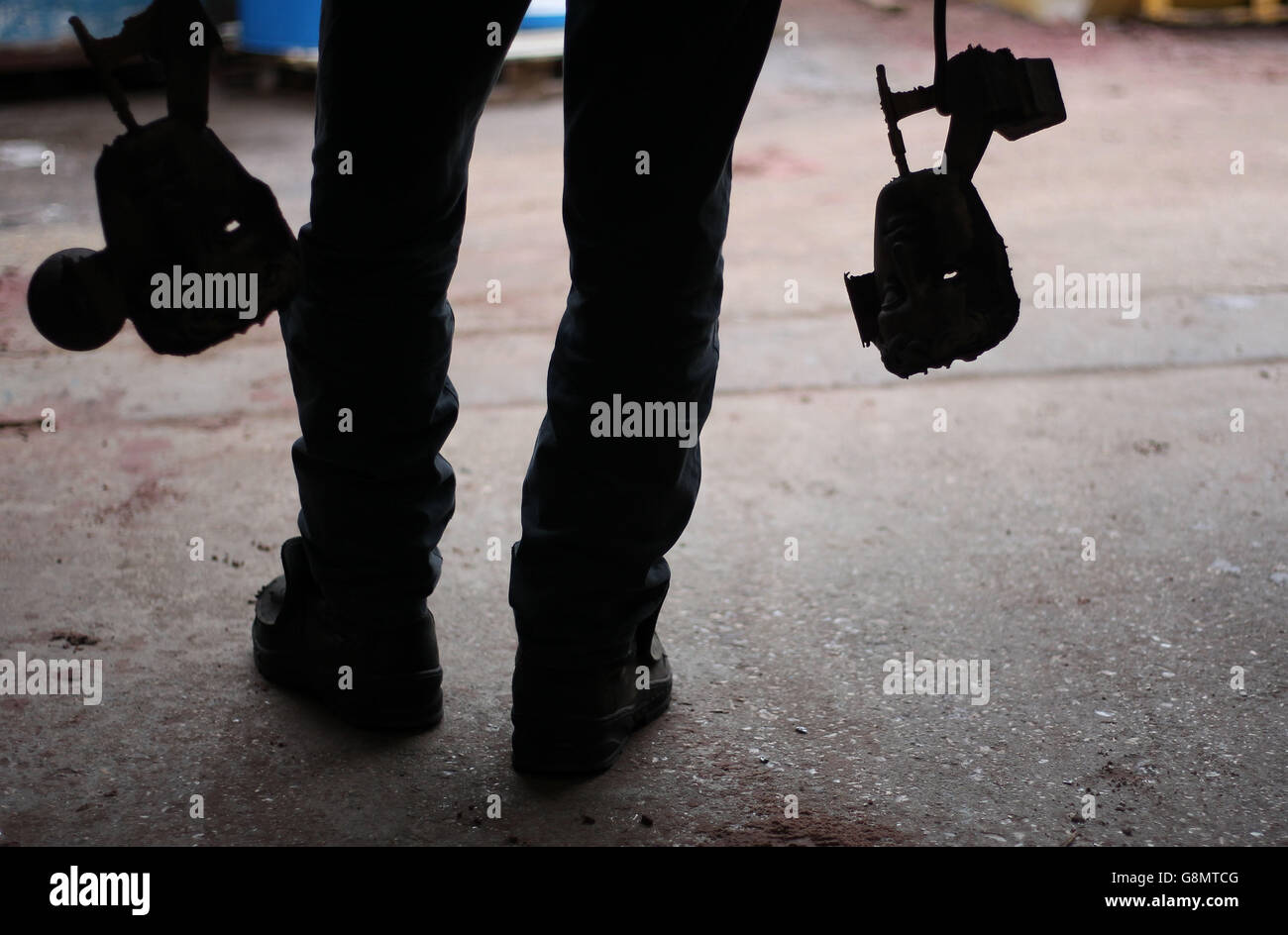 Bronze metal statues are cooled down as they are made into BAFTA masks ...