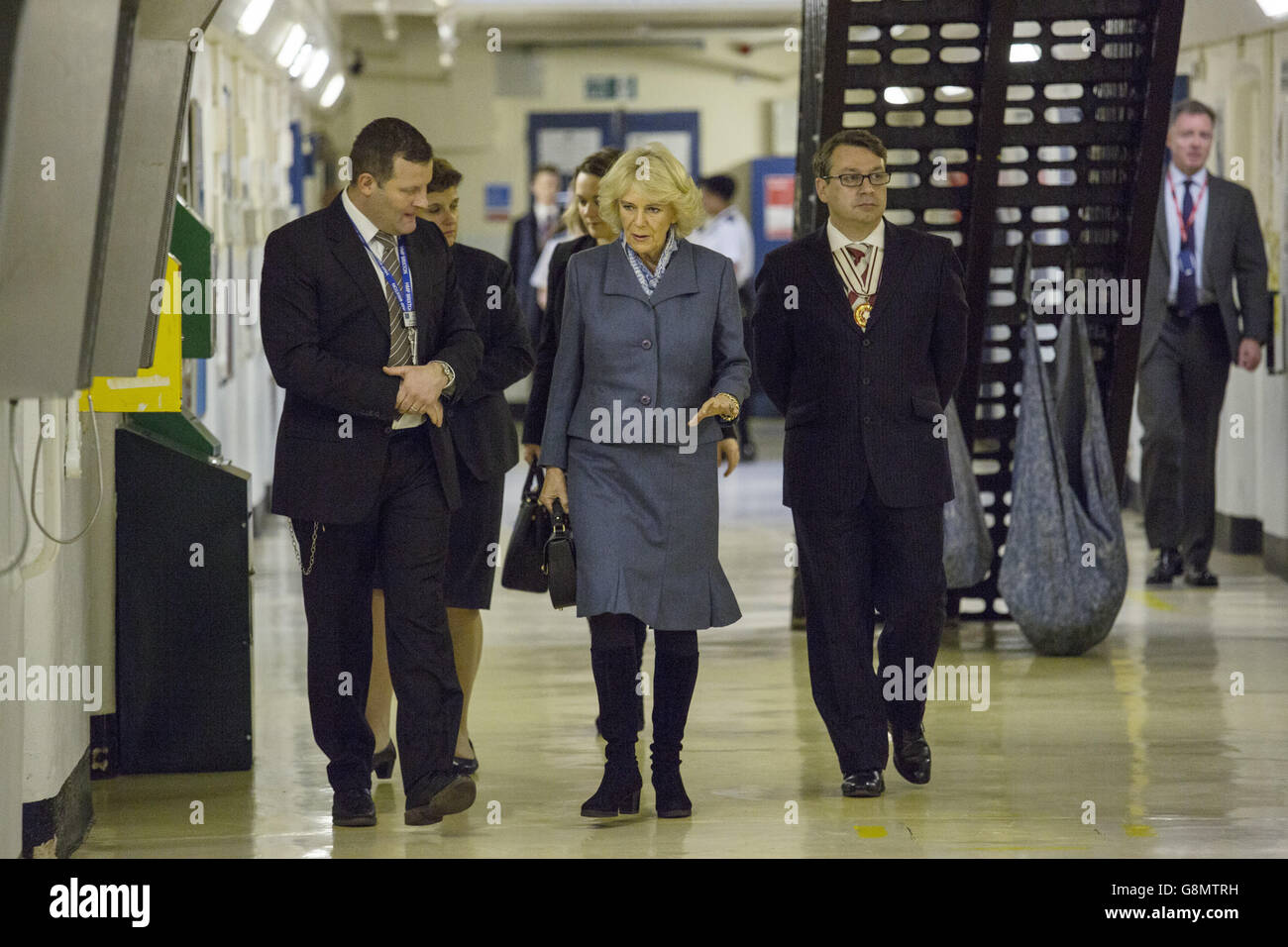 The Duchess of Cornwall walks with Governor Giles Mason (left) and ...
