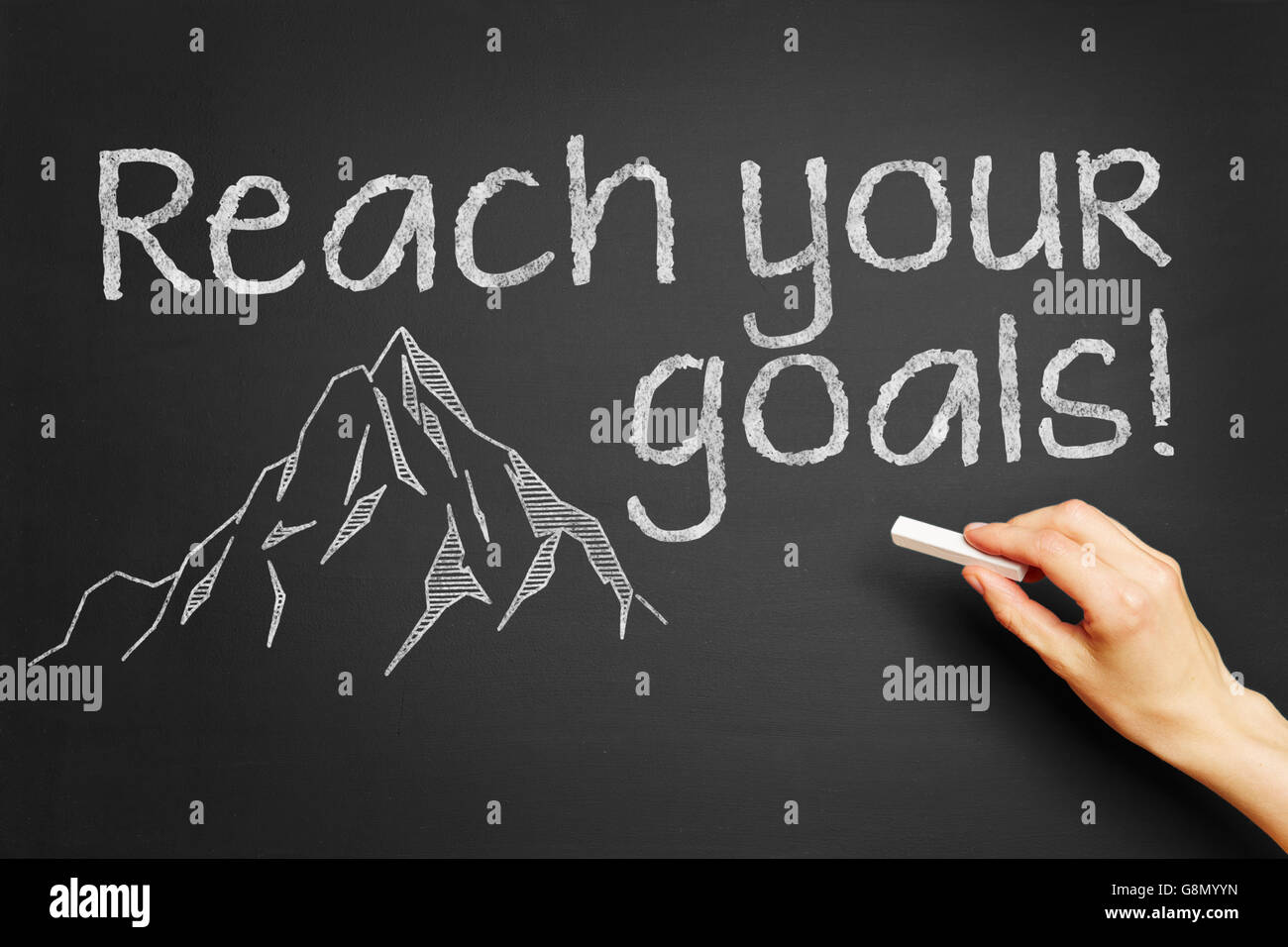 Hand writes "Reach your goals!" on blackboard Stock Photo - Alamy