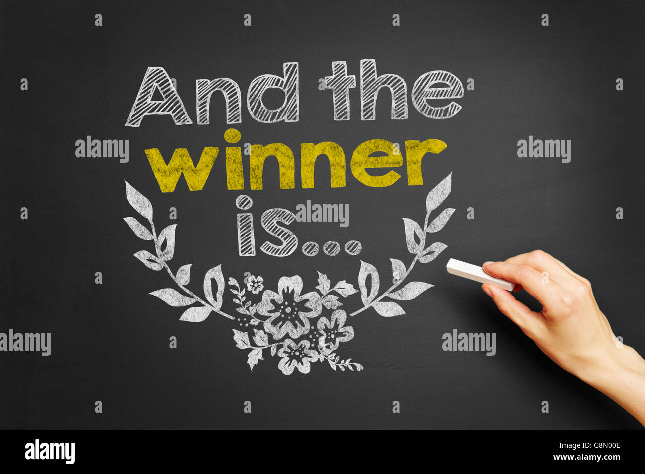 Hand writes "And the winner is..." on blackboard Stock Photo - Alamy