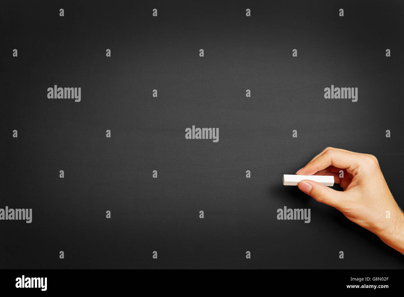 Hand in front of clean blackboard Stock Photo - Alamy