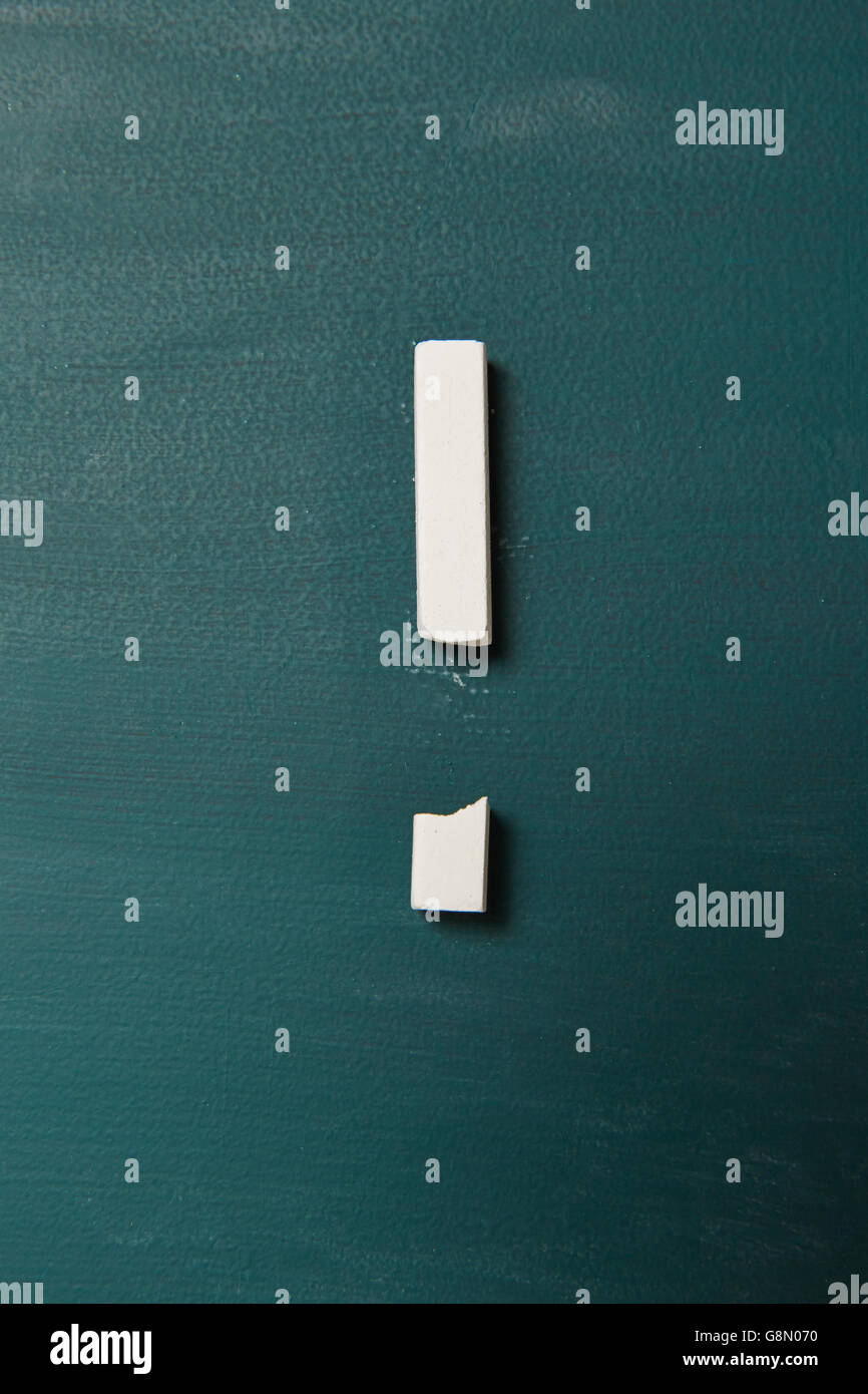 Broken chalk used as exclamation point on clean green chalkboard Stock ...
