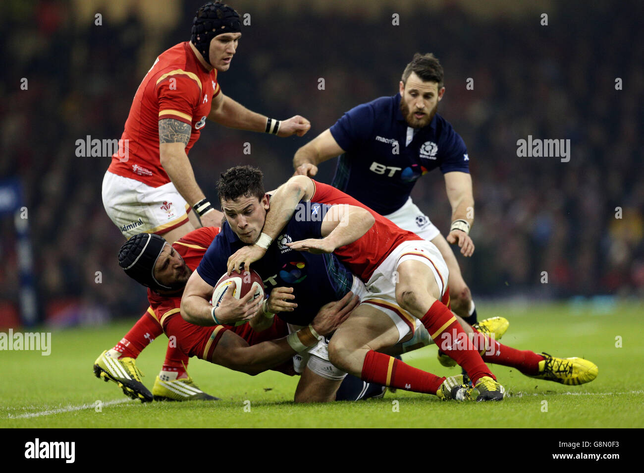 Scotland's John Hardie is tackled by Wales Gareth Davies and Luke ...