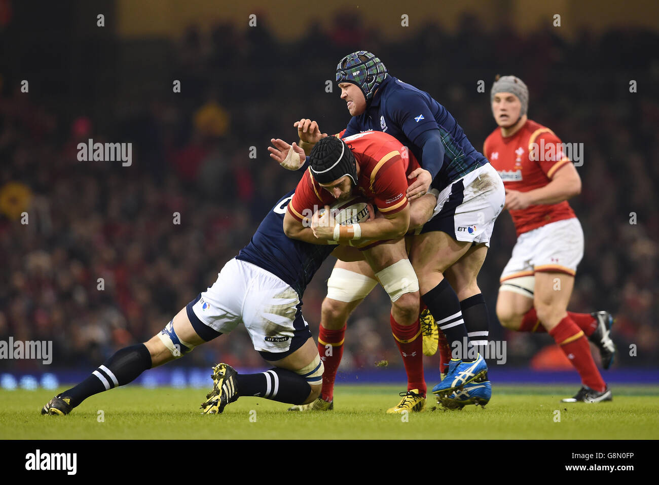 Wales' Luke Charteris is tackled by Scotland's David Denton (left) and ...