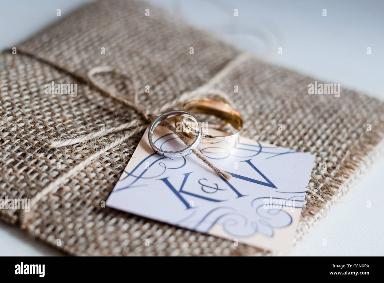 Wedding invitation with two wedding rings sat on top Stock Photo - Alamy