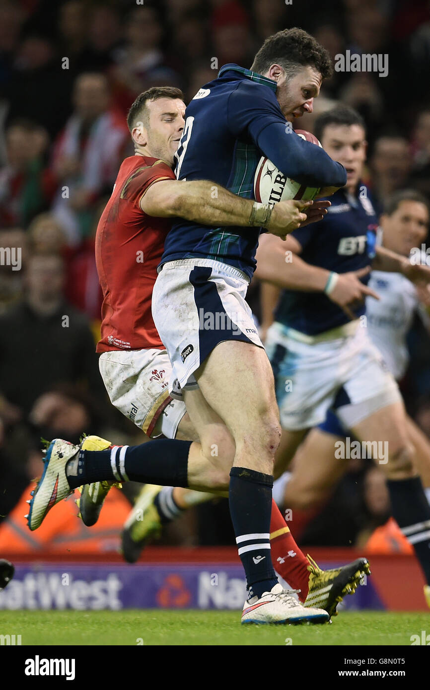 Scotland's Duncan Taylor (right) is tackled by Wales' Gareth Davies as ...
