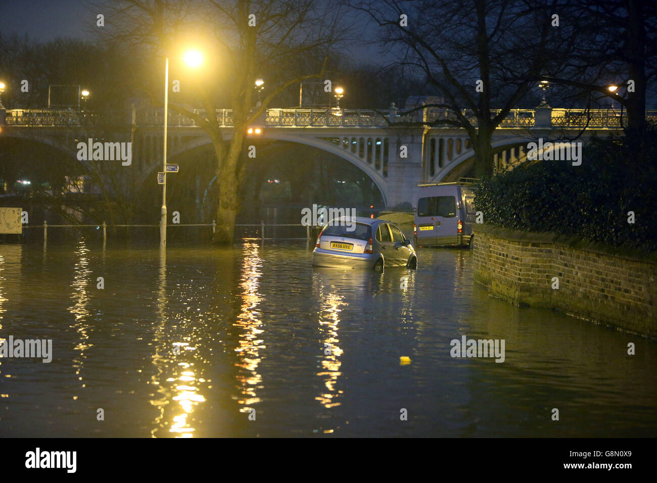 The River Thames floods a road near Richmond, west London at high tide ...