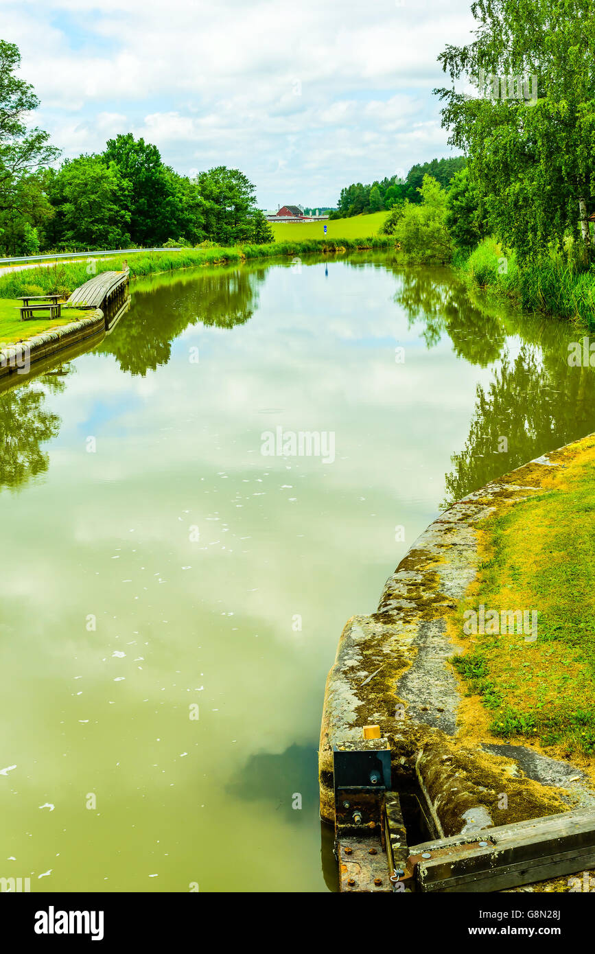 Landscape along part of the Gota canal in Sweden with a mooring pier or ...