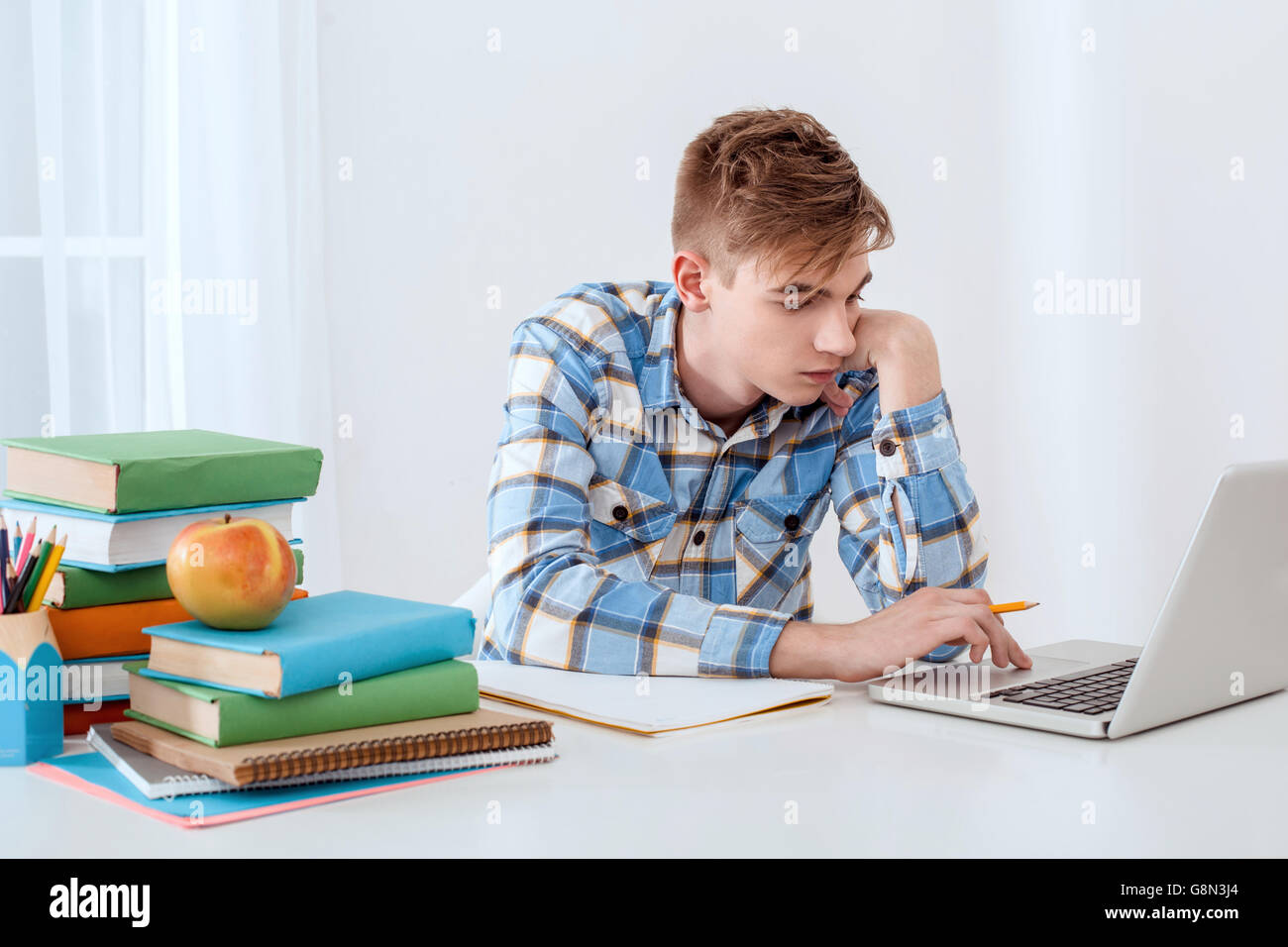 Modern problem: youth and computers. Young student using laptop and ...