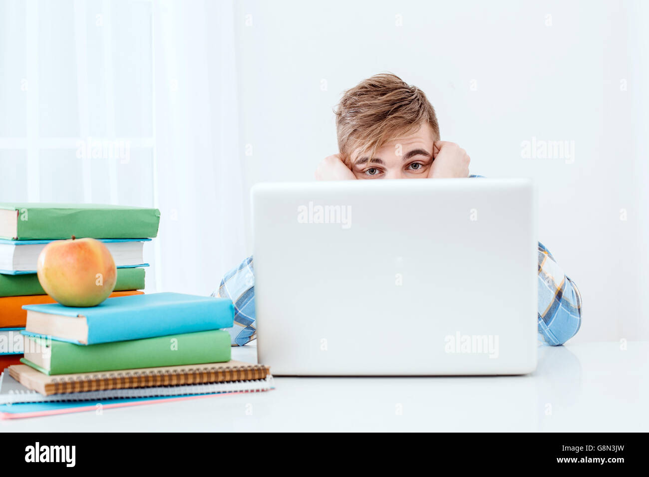 Modern problem: youth and computers. Young student using laptop and ...