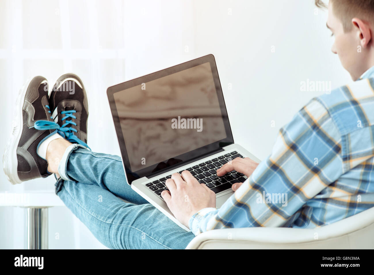 Modern problem: youth and computers. Young student using laptop. Nice ...