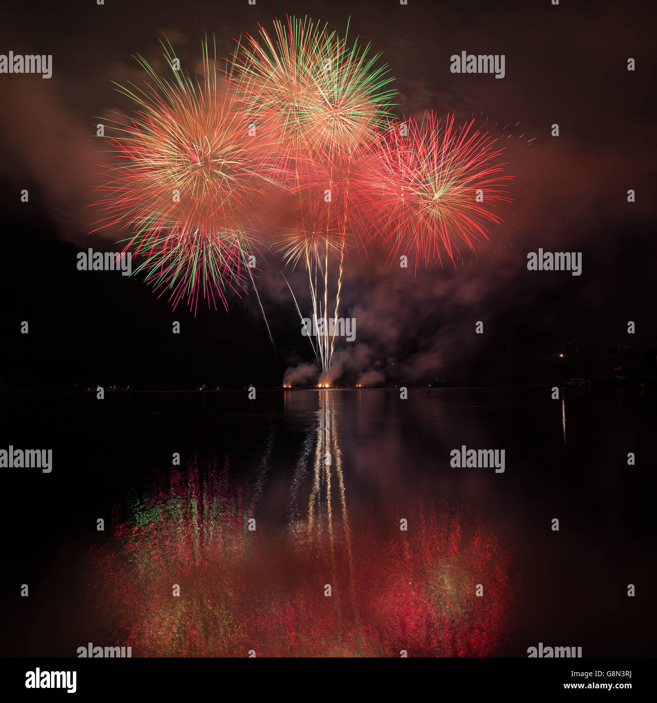 Colorful fireworks with reflection on lake and night sky in background ...