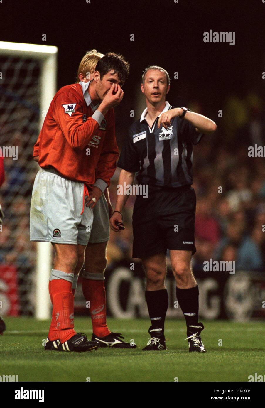Blackburn Rovers' Chris Sutton (left) holds his bleeding nose as ...