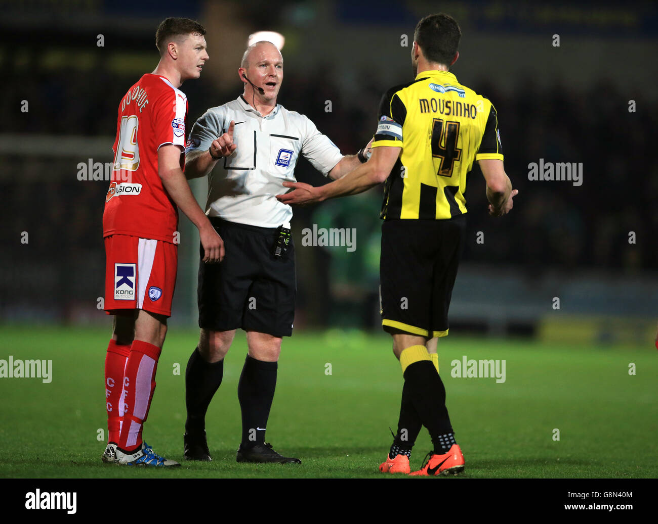 Referee Simon Hooper talks with Chesterfield's Dion Donohue (left) and ...