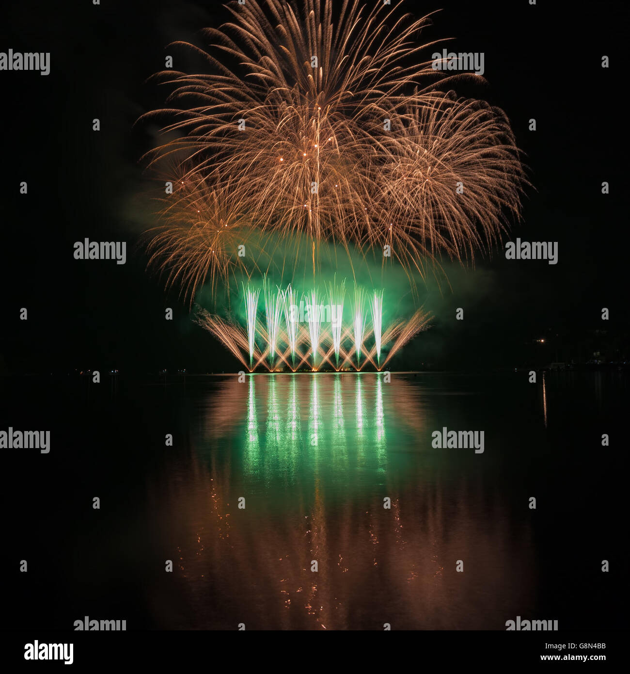 Colorful fireworks with reflection on lake and night sky in background ...