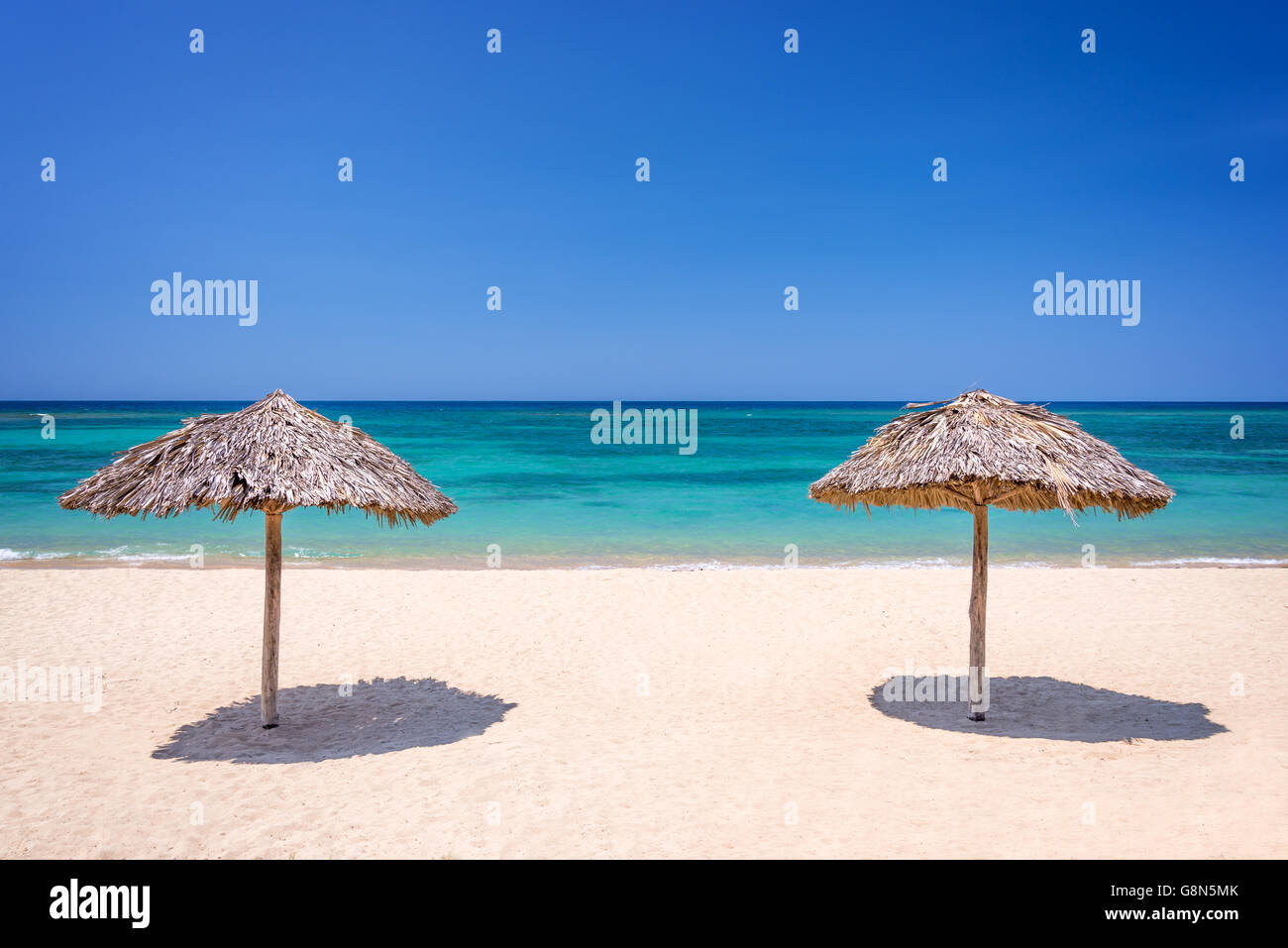 Caribbean tropical beach straw umbrella hi-res stock photography and ...